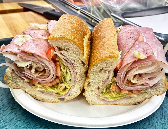Behold the Italian hoagie in all its glory – layers of meat and cheese stacked with such precision it could make an architect weep.