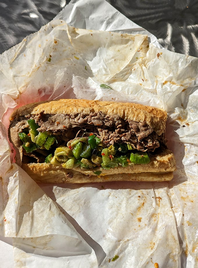 Behold the star of the show: thinly sliced beef piled high, giardiniera adding that essential kick. The Italian beef in all its messy glory.