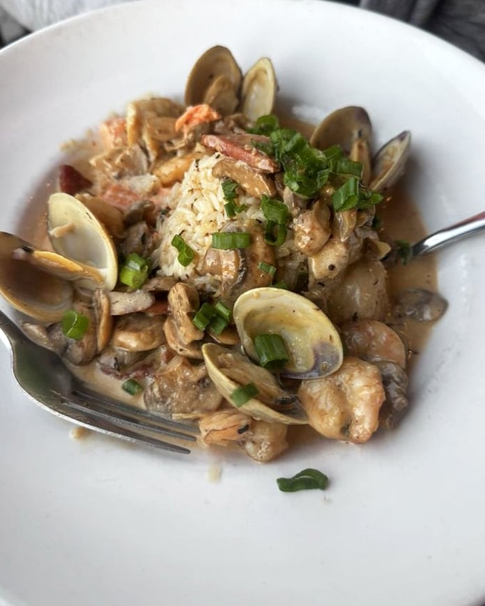 This isn't just jambalaya&mdash;it's a seafood symphony where each clam and shrimp has been introduced to spices that make them sing in perfect harmony.