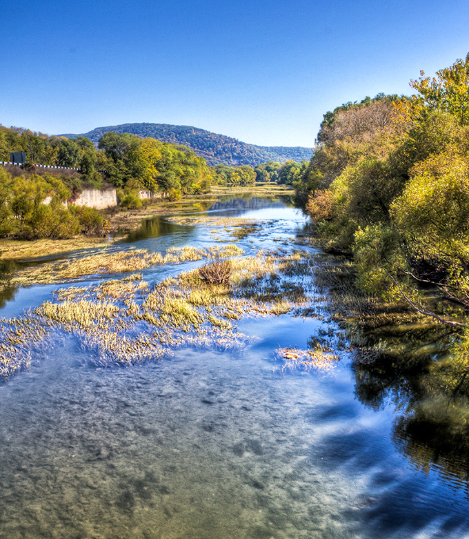 The Juniata River meanders through autumn splendor, reflecting golden light like liquid sunshine through the valley.