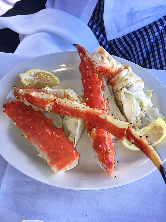 King crab legs sprawl majestically across the plate like nature's version of seafood royalty, demanding nothing less than your complete attention.