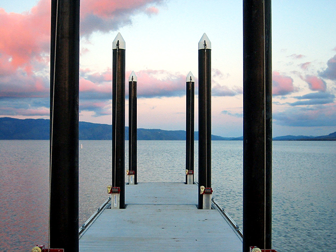 Sunset transforms this simple dock into a gateway to dreams, where pink-tinged clouds reflect in waters that have seen 2.5 million years of sunsets.