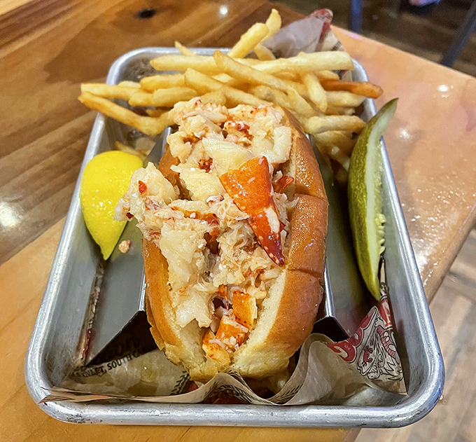 The lobster roll arrives like a celebrity on a metal tray&mdash;chunks of sweet meat nestled in a buttery bun with crispy fries standing guard.