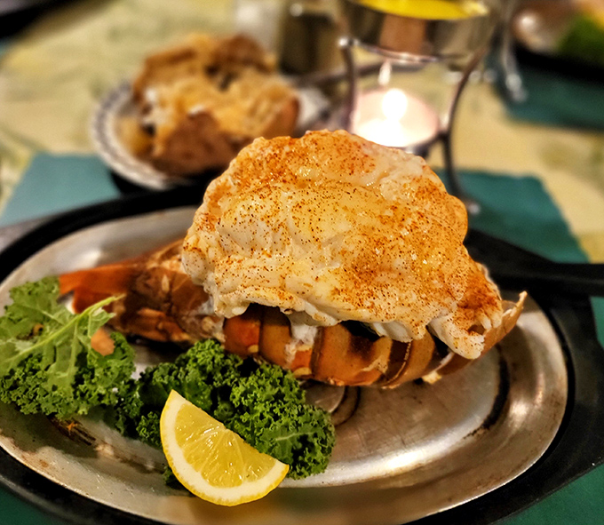 The star of the show arrives: a perfectly prepared lobster tail perched atop vegetables like a crown jewel of the northwoods.