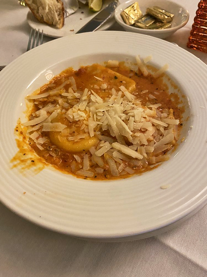 The legendary lobster ravioli arrives like a work of art, swimming in a tomato cream sauce that would make an Italian grandmother weep with joy.