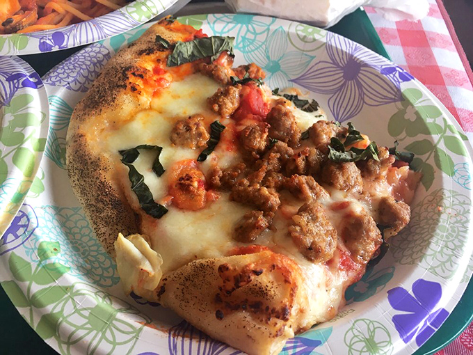 This isn't just pizza&mdash;it's edible poetry. The sausage-topped pie features that perfect balance of crisp crust, tangy sauce, and melted cheese.