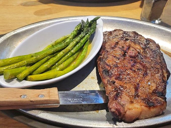 The star of the show: a perfectly seared ribeye alongside bright asparagus. This isn't just dinner&mdash;it's Michigan's answer to carnivorous prayers.
