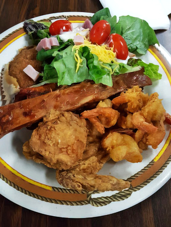 A plate that tells the whole story—golden fried chicken, savory sides, and fresh greens. This isn't just lunch; it's edible therapy for the soul.
