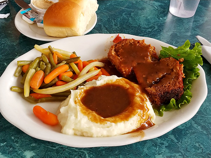 Meatloaf that doesn't apologize for being meatloaf. Those mashed potatoes have a gravy divot that would make professional golfers jealous.