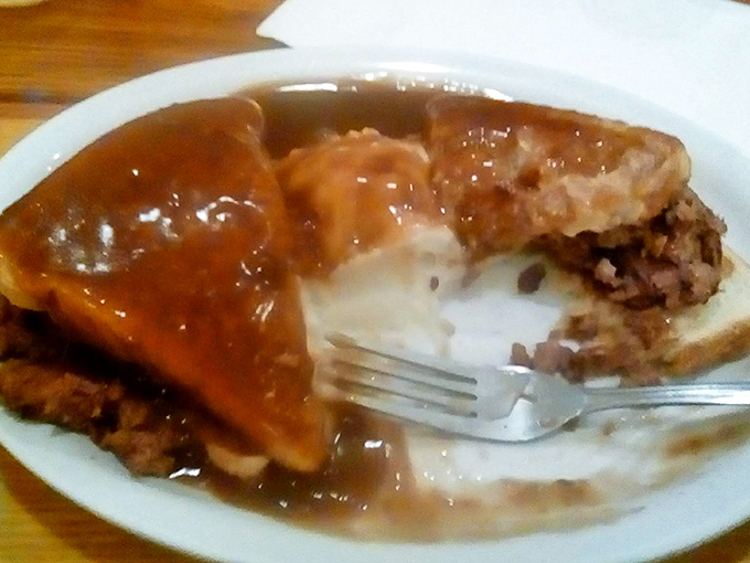 This meatloaf isn't just dinner&mdash;it's therapy on a plate. The gravy glistens with promise while the fork stands ready for the relationship to begin.