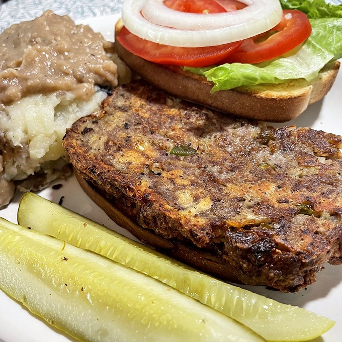 This meatloaf doesn't just sit on the plate&mdash;it commands attention with its perfectly caramelized exterior and hearty presence alongside real mashed potatoes.