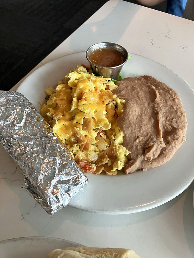 Scrambled eggs that look like they've been whispered into perfection, paired with beans and tortillas. Breakfast diplomacy between Texas and Mexico.