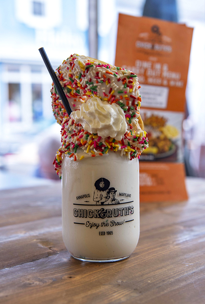 This milkshake arrives dressed for celebration, proving that breakfast dessert is absolutely a legitimate life choice.