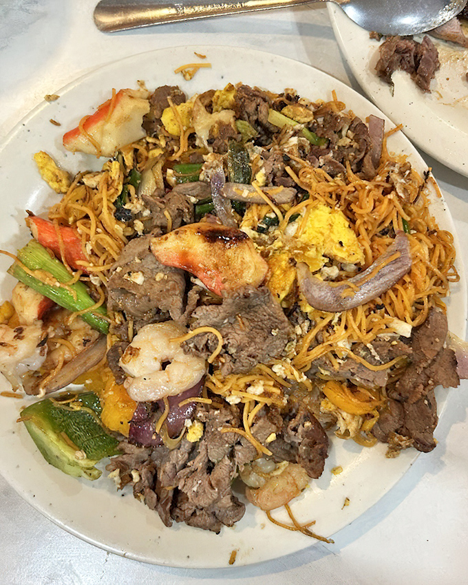 A plate that tells the story of land and sea coming together in perfect harmony. Noodles, beef, shrimp, and vegetables dancing in delicious unity.