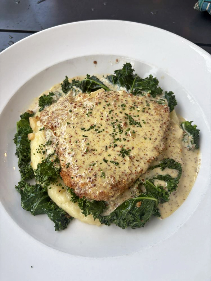 This isn't just chicken&mdash;it's a masterclass in comfort, nestled on a bed of greens and bathed in a sauce that whispers, "Cancel your afternoon plans."