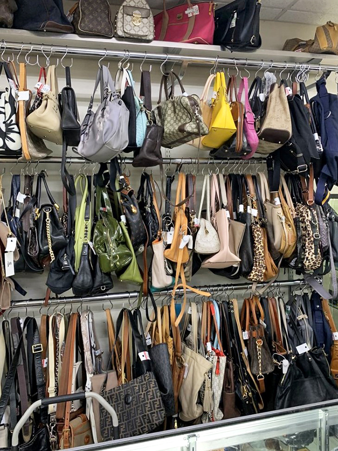 Handbag heaven or purse purgatory? Designer labels mingle with vintage classics in this hanging garden of accessories waiting for their second act.