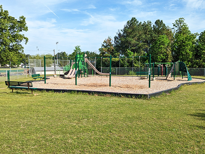 Childhood still happens outdoors here—this playground stands ready for the timeless soundtrack of laughter and the squeak of swings.