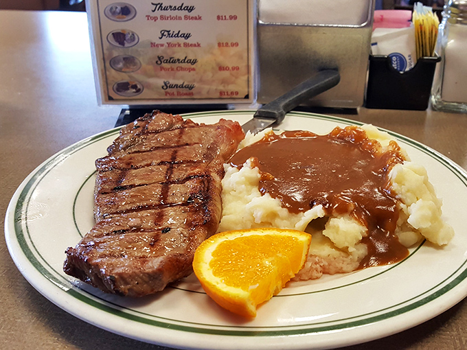 Behold the star attraction: a perfectly grilled New York steak alongside gravy-laden mashed potatoes. This isn't just dinner&mdash;it's edible therapy after a long day.