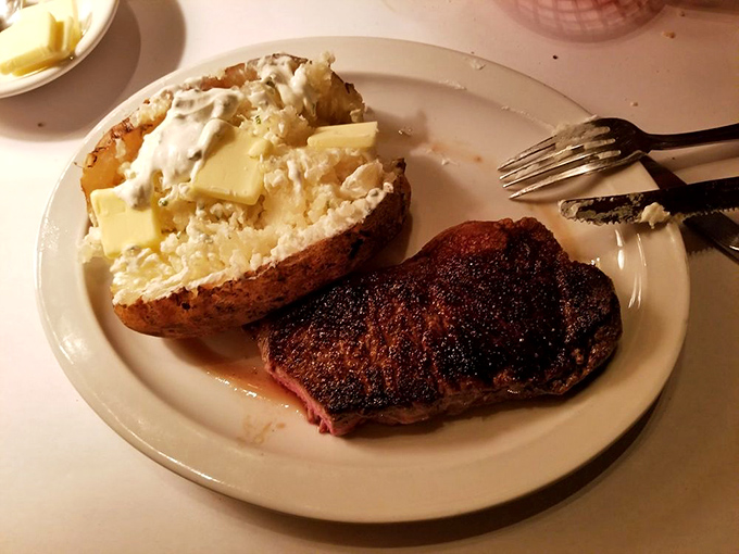 This isn't just a steak; it's a declaration of independence from food fads &ndash; a perfectly seared New York strip with a loaded baked potato that screams "America!"