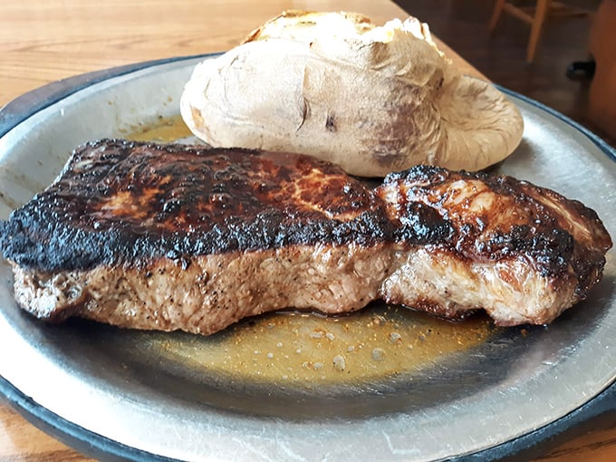 A perfectly seared New York strip that doesn't need fancy garnishes &ndash; just a humble baked potato and your undivided attention.
