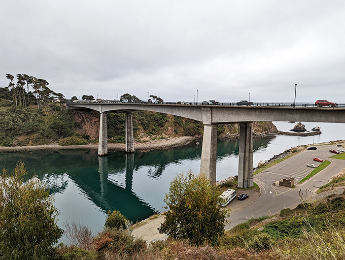 The Noyo River Bridge stands like a gateway to adventure, connecting the headlands while offering a bird's-eye view of the harbor's bustling fishing boats below.