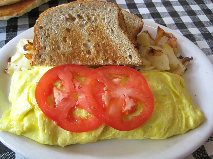 Sunshine on a plate! This omelet practically glows with freshness, flanked by perfectly golden hashbrowns and toast soldiers standing at attention.