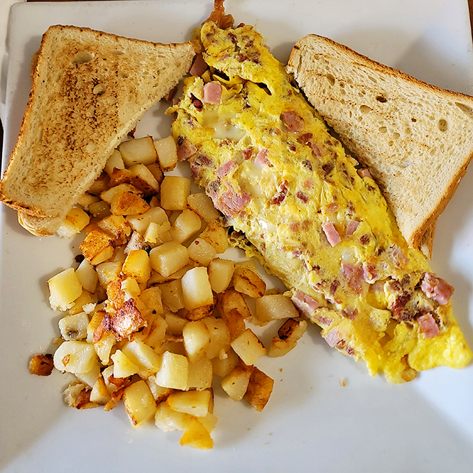 This ham and cheese omelet isn't just breakfast &ndash; it's edible architecture with perfectly golden edges and a molten cheese interior.