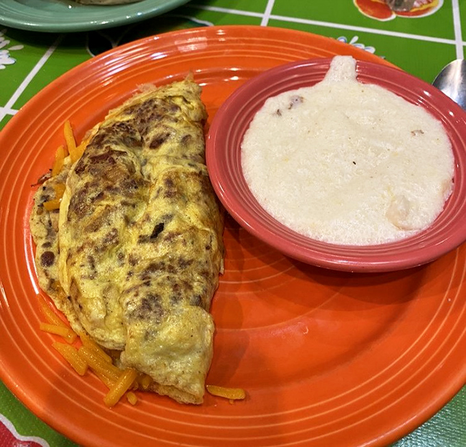 That perfect fold, that golden exterior&mdash;this isn't just an omelet, it's breakfast architecture with a side of creamy grits for good measure.