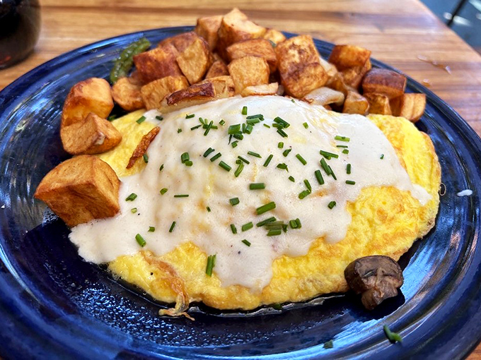 This isn't just any omelet&mdash;it's a fluffy golden pillow topped with a silky sauce that makes those home-cooked attempts seem like sad, deflated cousins.