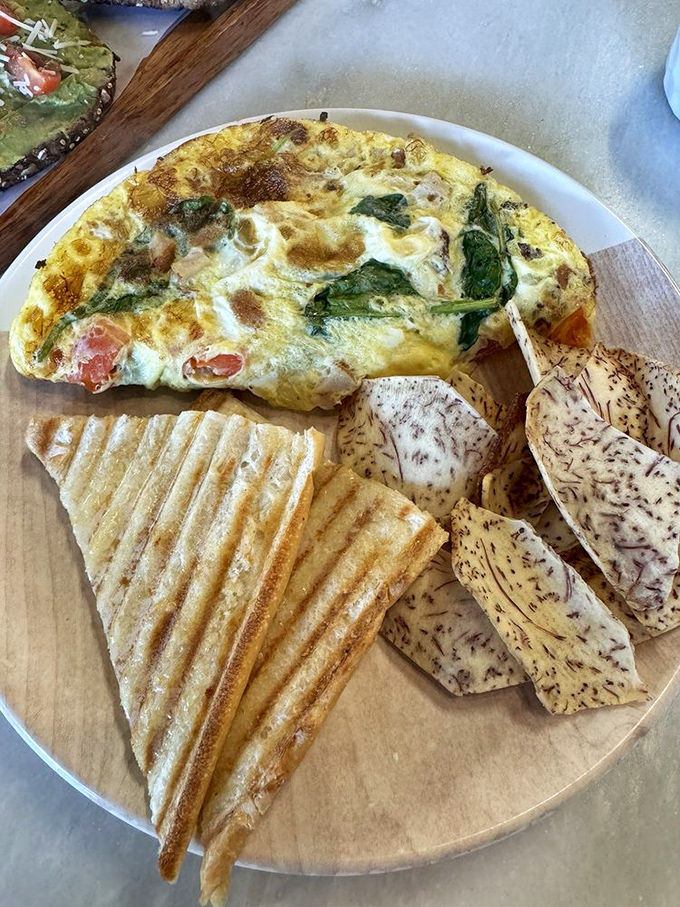 This Problem Omelette solves all breakfast dilemmas with its perfect fluff-to-filling ratio and crispy toast sidekicks standing at attention.