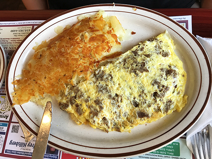 Behold, the legendary omelet in its natural habitat. Perfectly folded, generously filled, and paired with hash browns that deserve their own fan club.