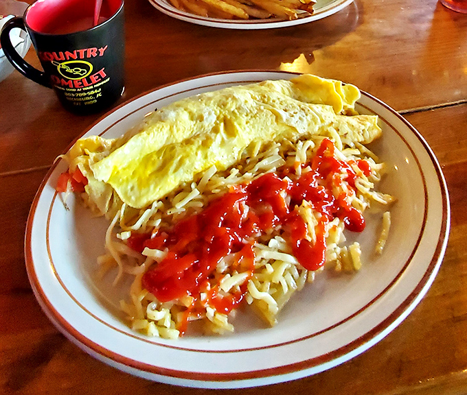 Eggs transformed into art! This fluffy creation stuffed with cheese and topped with what appears to be salsa proves breakfast doesn't have to be complicated to be magnificent.