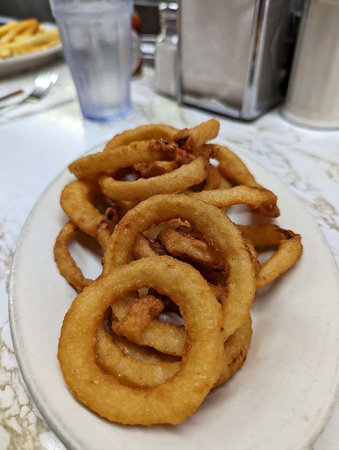 Golden halos of happiness! These hand-battered onion rings shatter with a satisfying crunch that'll make you question all other rings you've known.