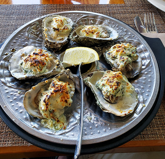 These oysters Rockefeller aren't just baked, they're living their best life under a blanket of herbs and cheese.