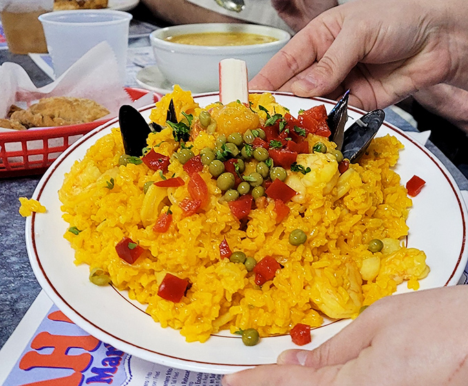 Saffron-kissed rice cradles a treasure trove of seafood in this paella that makes you wonder why you ever bothered with land-based foods.