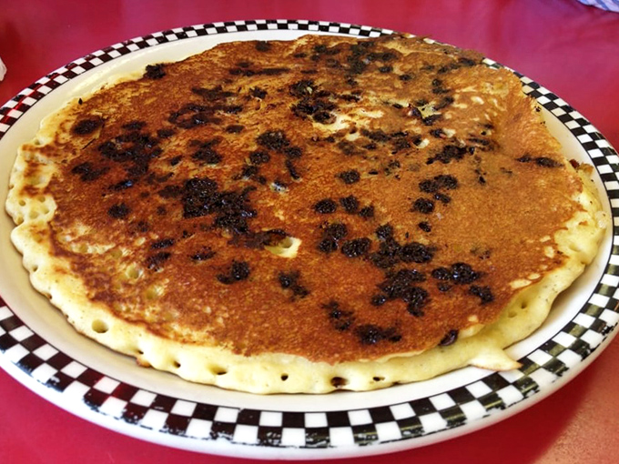 Behold the famous chocolate chip pancake in all its golden glory – a perfect canvas of fluffy batter studded with melty morsels that would make any breakfast enthusiast weak at the knees.