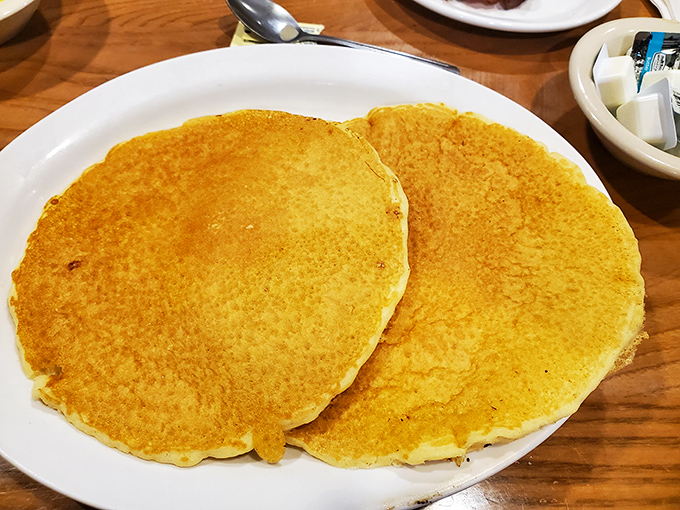 These golden pancakes arrive like edible sunshine, ready to transform your morning into pure breakfast bliss.