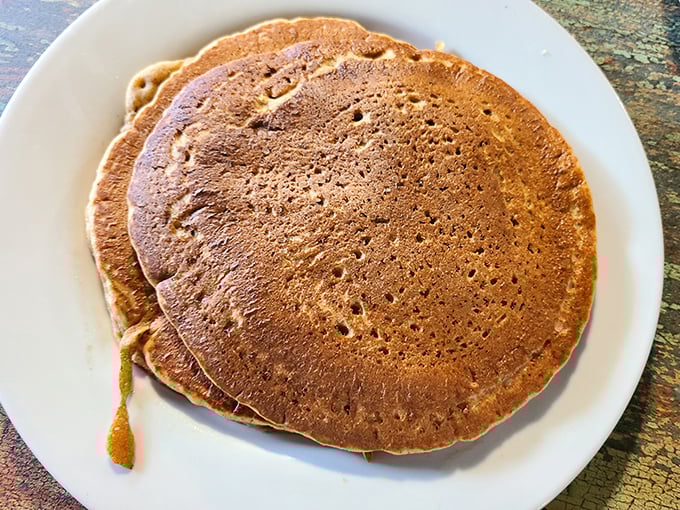 These golden-brown pancakes aren't just breakfast, they're therapy&mdash;perfectly porous to soak up syrup while maintaining their structural integrity. Engineering meets comfort food.