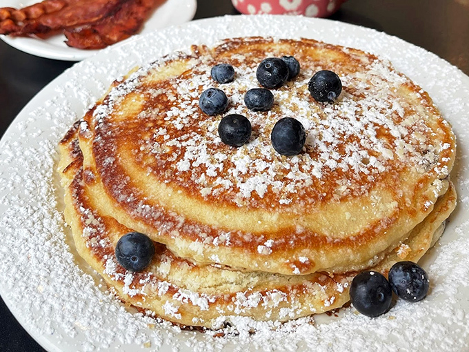 Golden discs of joy dusted with powdered sugar and crowned with blueberries. Pancake perfection doesn't need to shout.