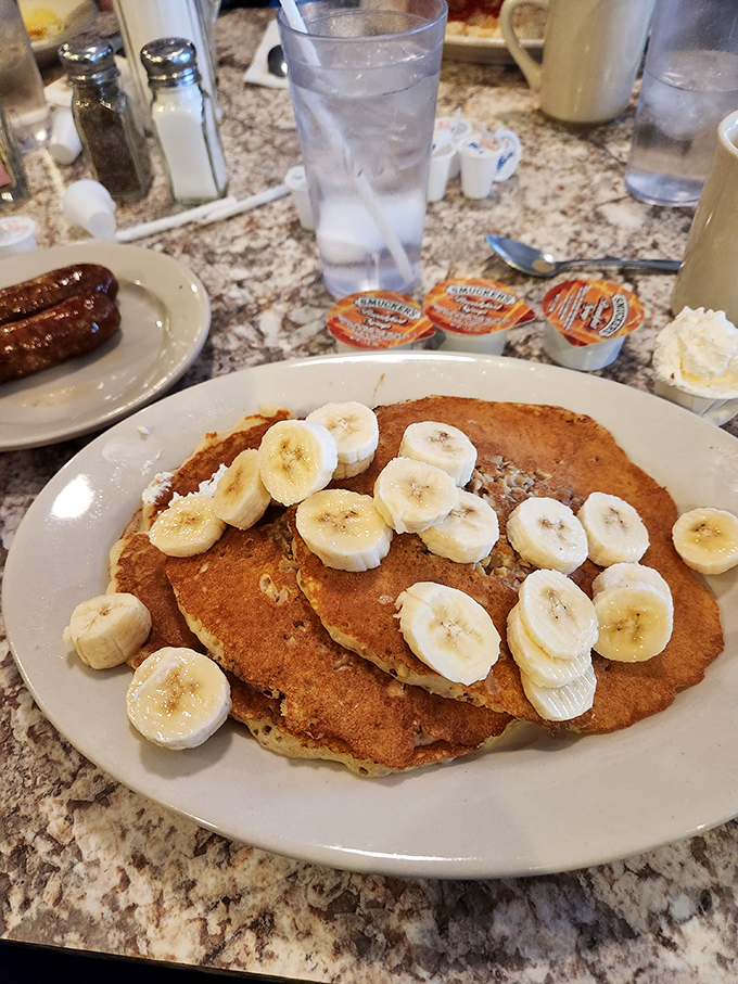 Pancakes that don't just arrive but make an entrance, wearing banana slices like medals of honor. Breakfast doesn't get more photogenic than this.