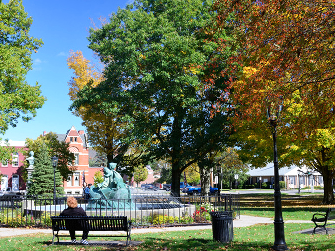 The town green offers a perfect respite, where locals gather around the fountain while autumn paints the surrounding trees in nature's most vibrant palette.