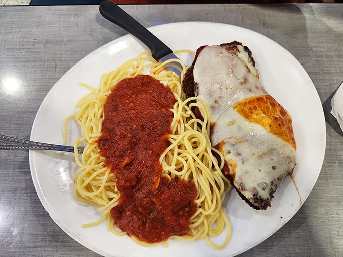 Spaghetti and garlic bread, the dynamic duo of diner cuisine. That sauce isn't just red, it's a tomatoey hug for your taste buds.