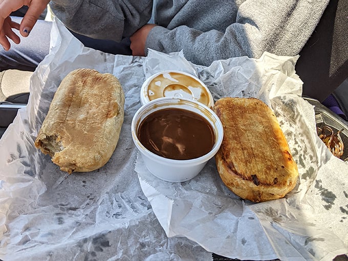Two golden-brown pasties with a side of gravy&mdash;a complete Upper Peninsula meal that miners once carried underground and tourists now travel hundreds of miles to experience.