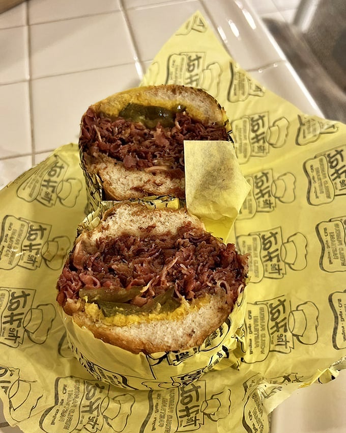 Behold the star of the show&mdash;layers of thinly-sliced pastrami piled so high you'll need to unhinge your jaw like a python.