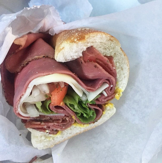 This isn't just a sandwich; it's a masterclass in meat architecture. The pastrami is stacked with the precision of a Jenga champion.