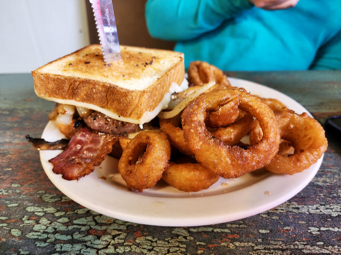 This patty melt arrives looking like it means business, with onion rings that could double as life preservers.