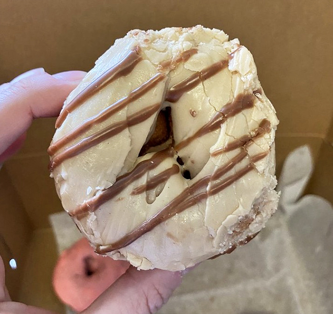 Peanut butter and chocolate stripes create the formal wear of the donut world. Like a tuxedo for your taste buds, this elegant creation proves that some relationships are simply meant to be.