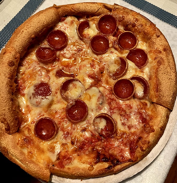 Pizza perfection in its natural habitat. Those curled pepperoni cups create little pools of flavor that make resistance utterly futile.