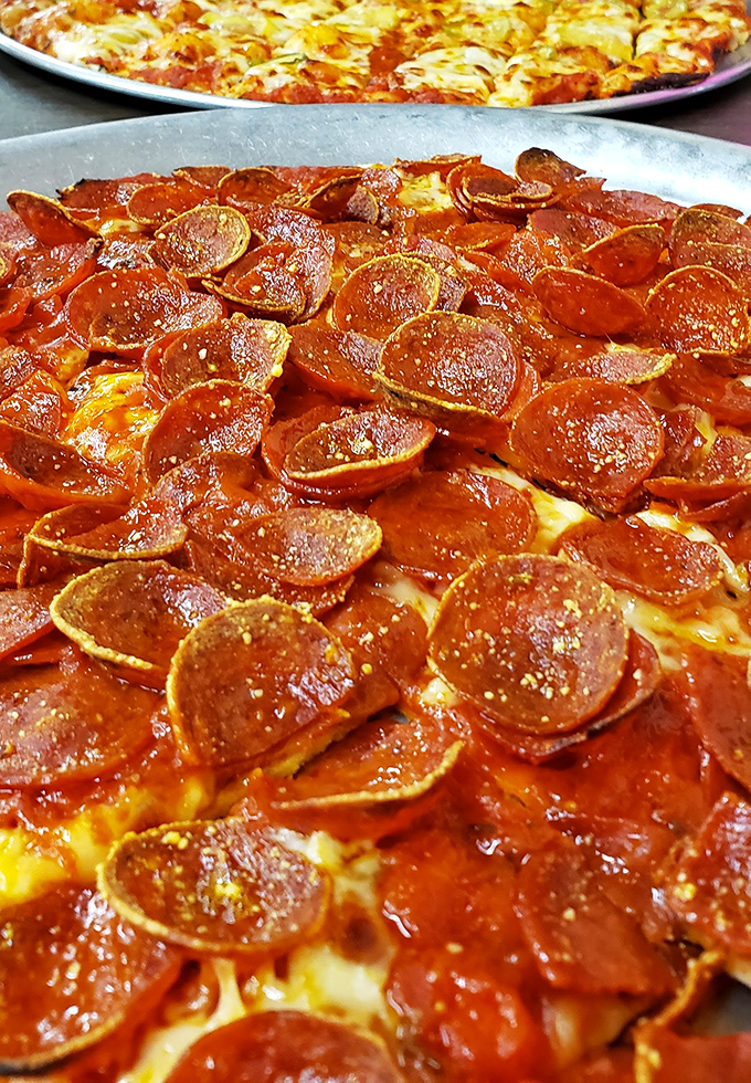 Those curled-up pepperoni cups are little flavor reservoirs of joy, collecting spiced oil like nature's perfect pizza condiment.