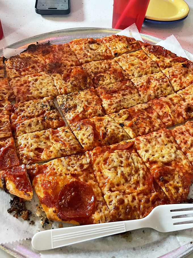 The square-cut pepperoni pizza isn't just food&mdash;it's edible geometry where each crispy corner piece becomes a treasured prize.